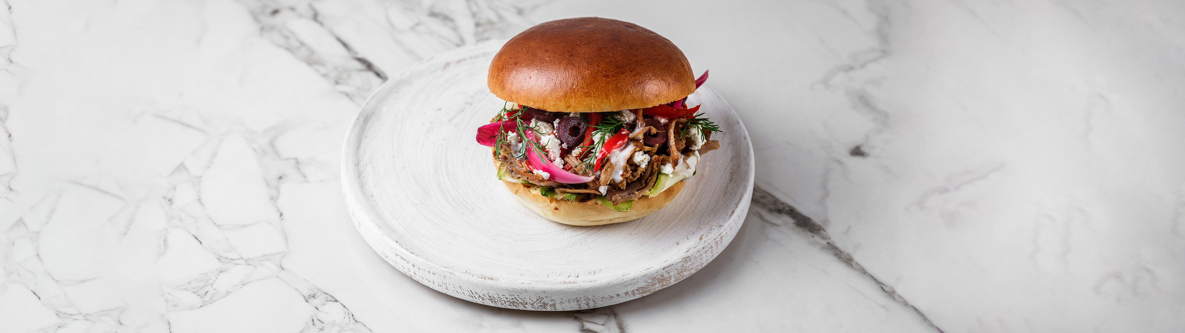 Beirut Lamb & Feta Burger with olives, yoghurt, and pickled cucumbers ...